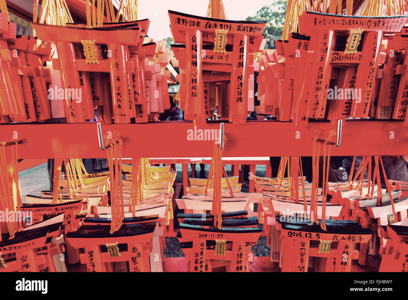 Small Torii gates with written wishes and offerings made of small ...