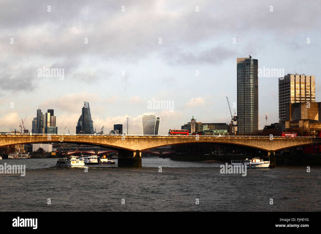 Red double deck bus crossing Waterloo Bridge, South Bank Tower (R ...