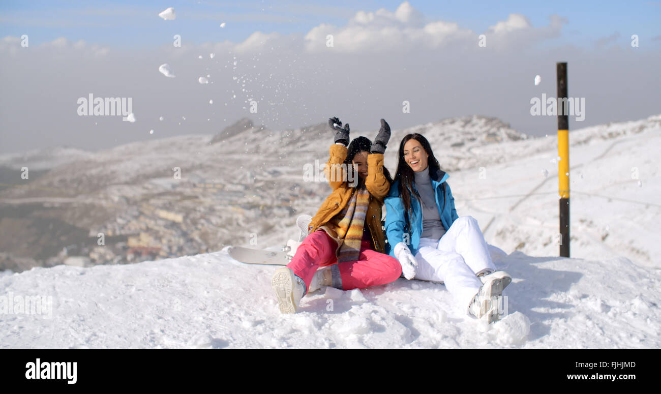Two young women having fun in winter snow Stock Photo - Alamy