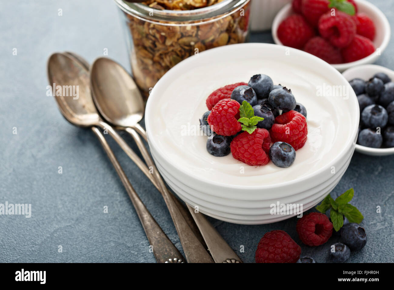 Natural yogurt in a bowl with berries Stock Photo - Alamy