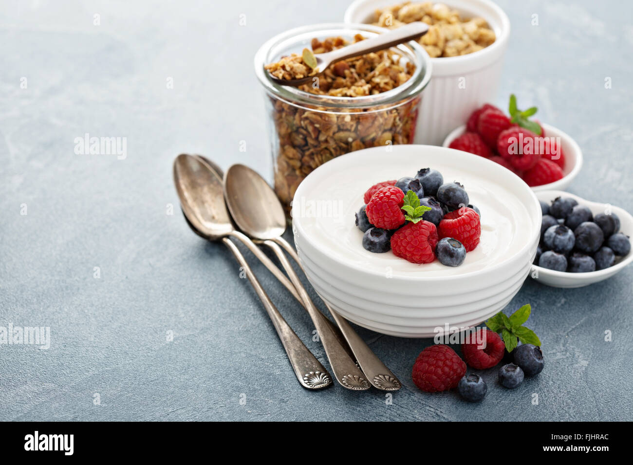 Natural yogurt in a bowl with berries Stock Photo - Alamy