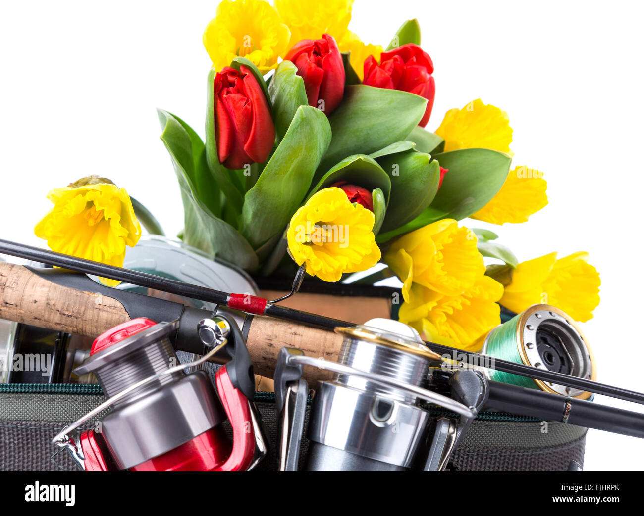 fishing tackles with spring flowers narcissus and tulips on white ...