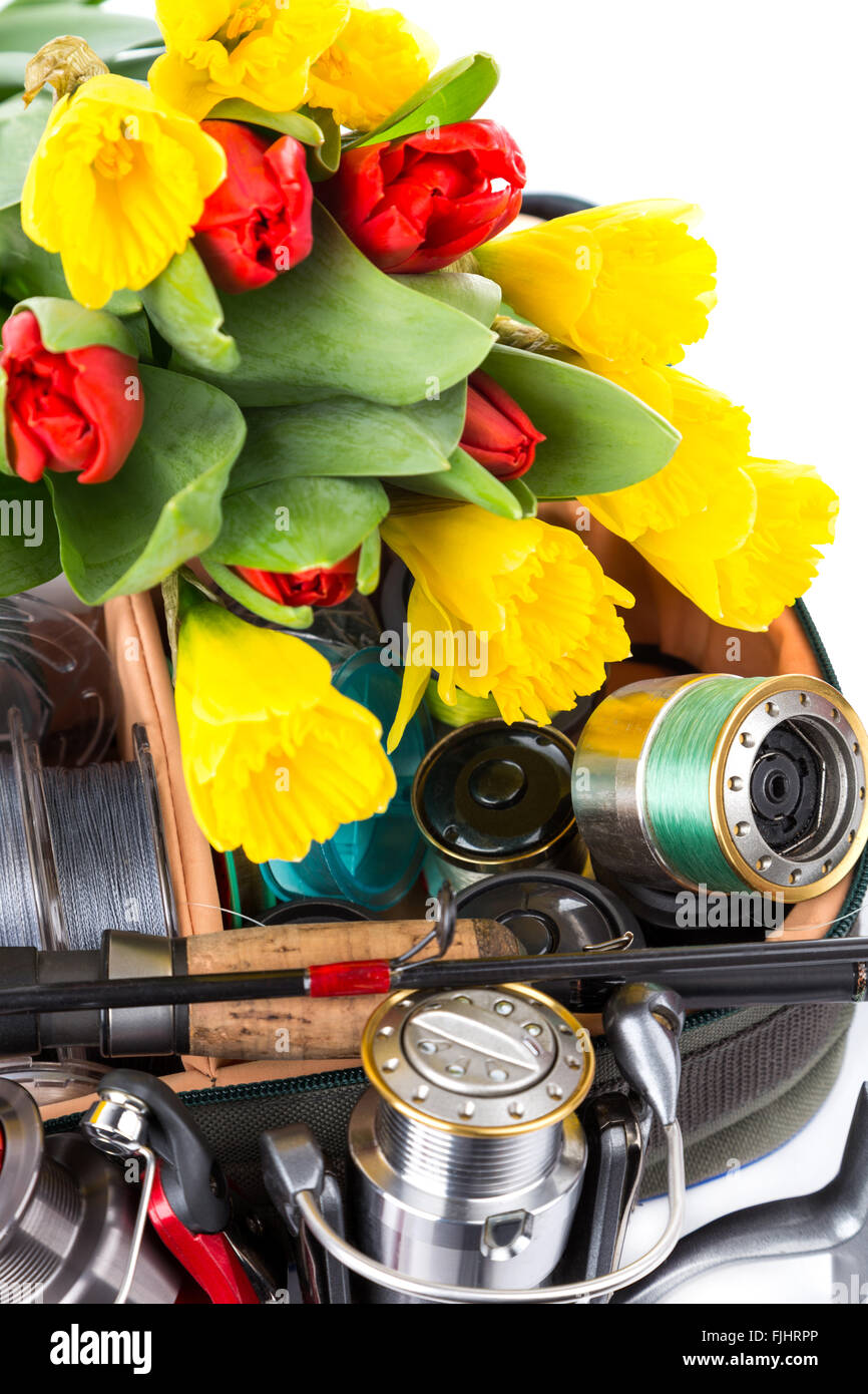fishing tackles with spring flowers narcissus and tulips on white ...
