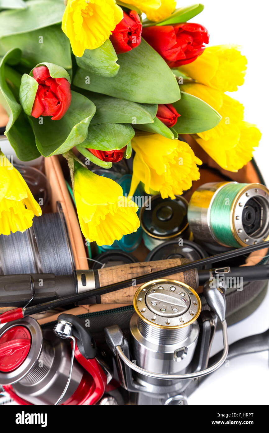 fishing tackles with spring flowers narcissus and tulips on white ...