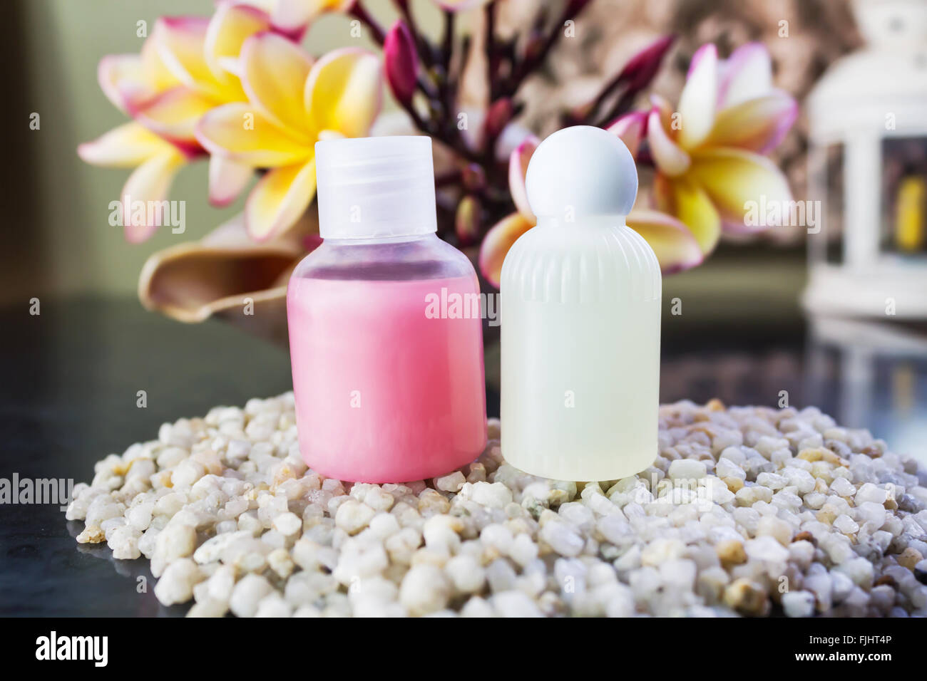 Mini set of shower bath soap, shampoo,conditioner on pebble and flower ...