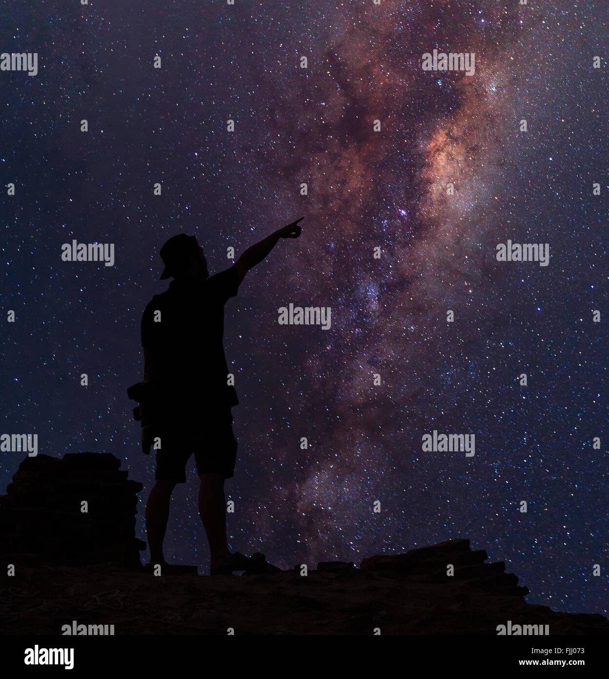 Star-catcher. A person is standing next to the Milky Way galaxy ...