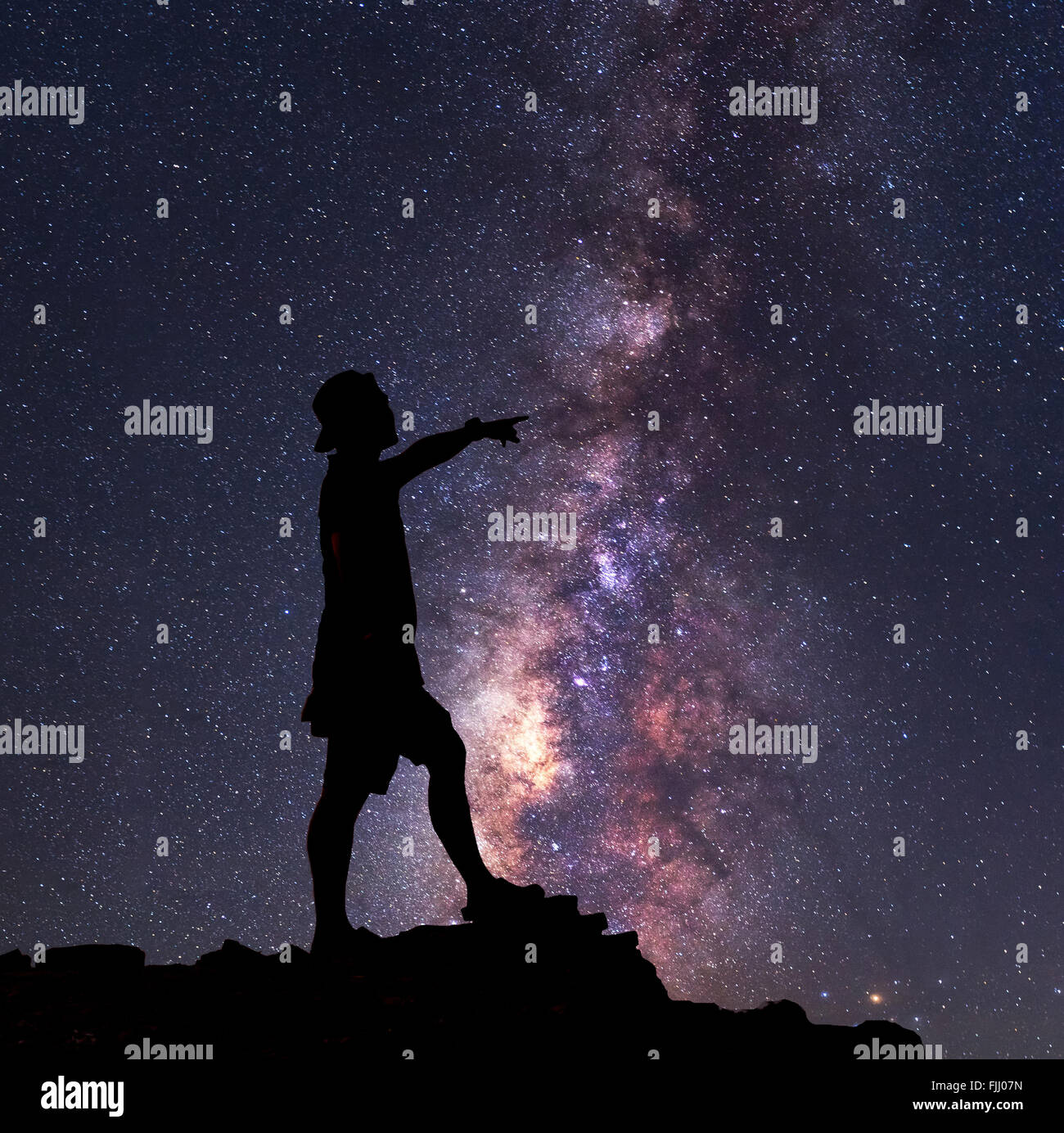 Star-catcher. A person is standing next to the Milky Way galaxy ...