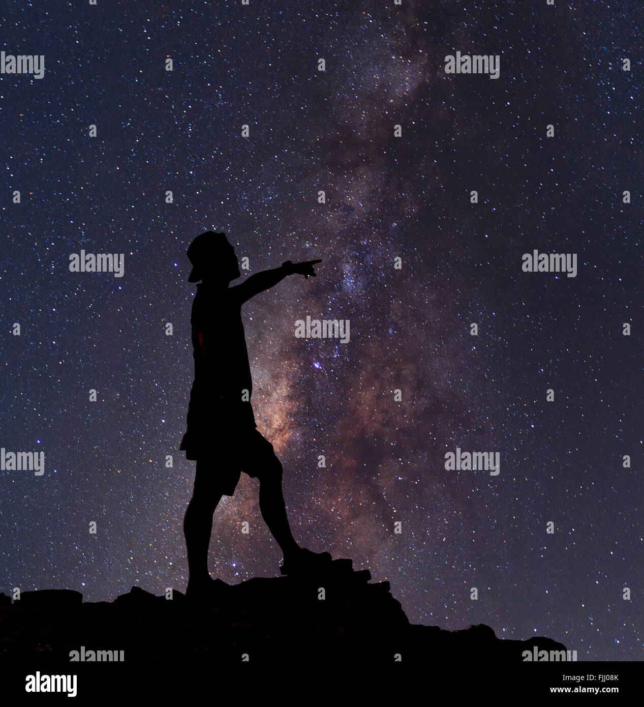 Star-catcher. A person is standing next to the Milky Way galaxy ...