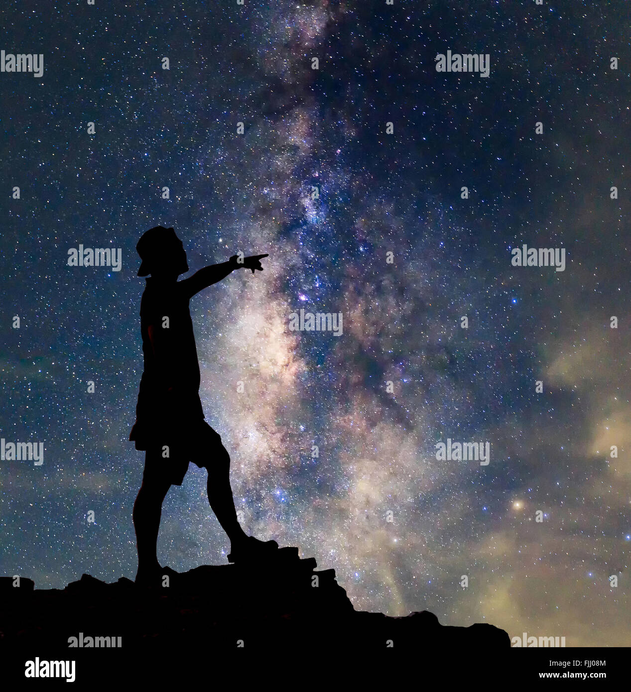 Star-catcher. A person is standing next to the Milky Way galaxy ...
