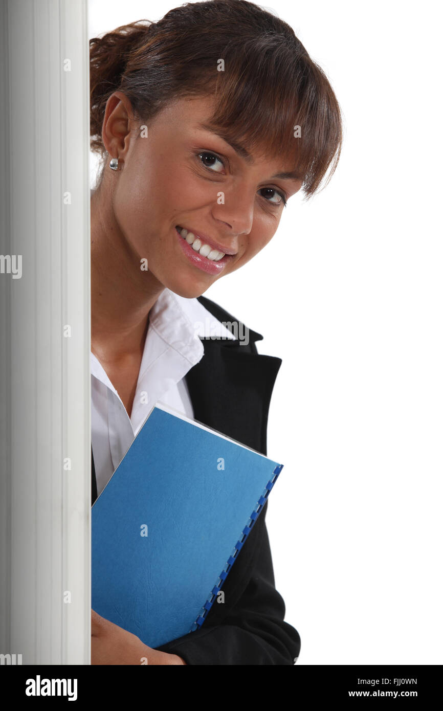 Woman standing behind a wall Stock Photo - Alamy