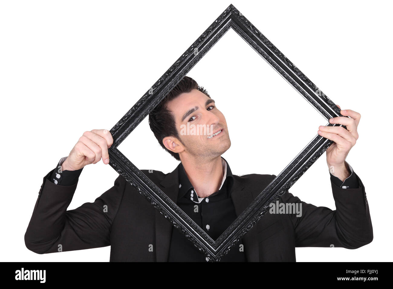 Man in suit carrying frame, on white background Stock Photo - Alamy