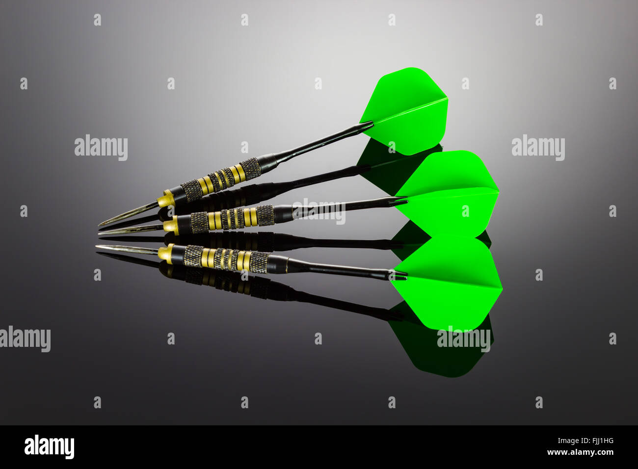 Green darts of the game Stock Photo - Alamy