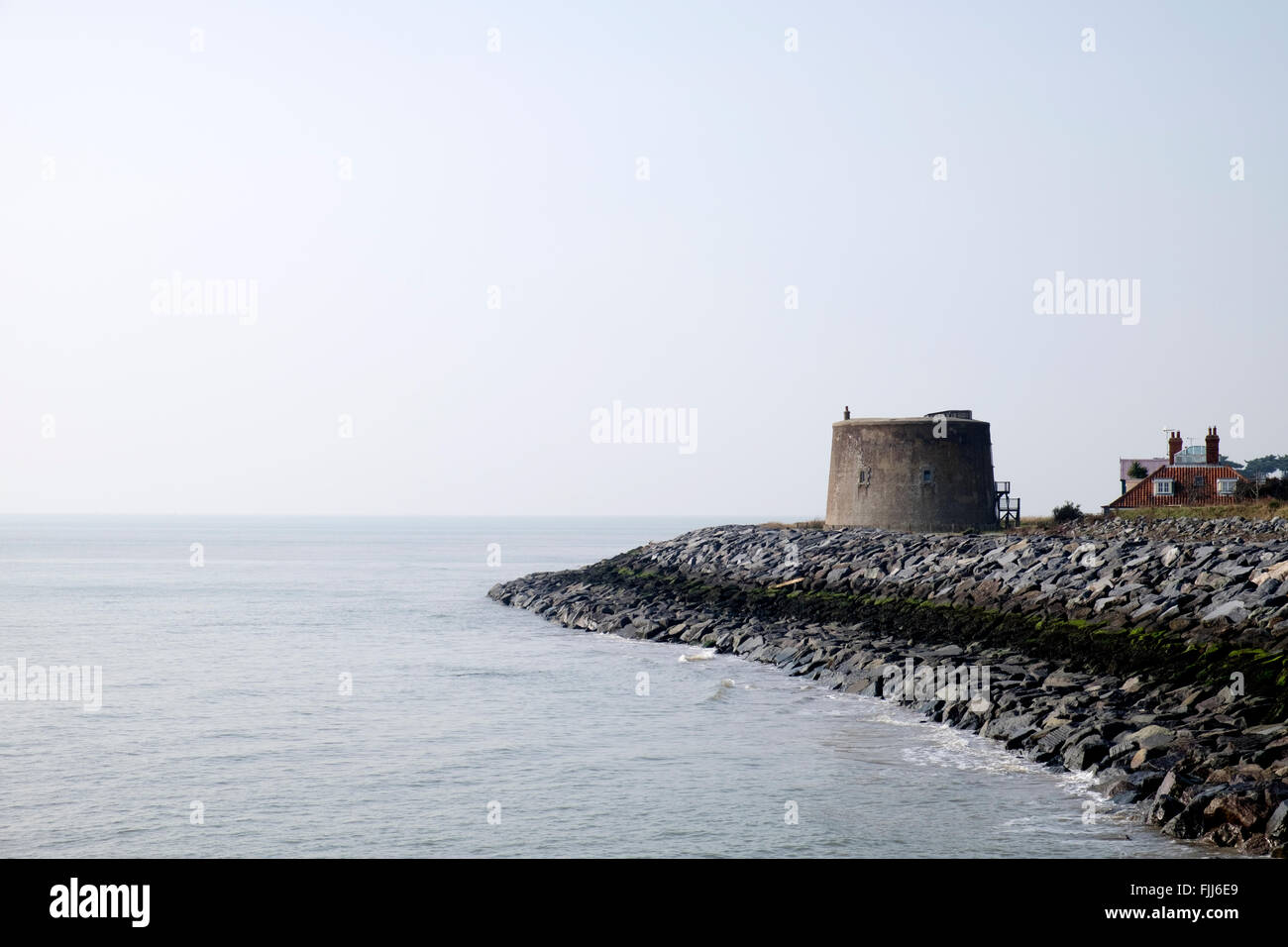 Rock armour protecting an historic Martello tower from coastal erosion ...