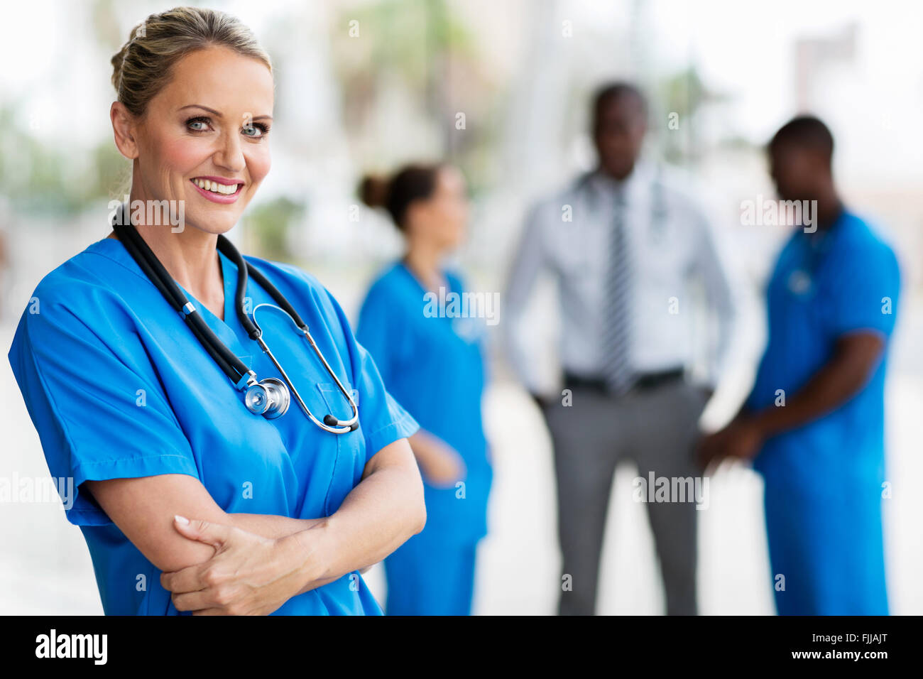 beautiful middle aged medical doctor arms crossed Stock Photo - Alamy