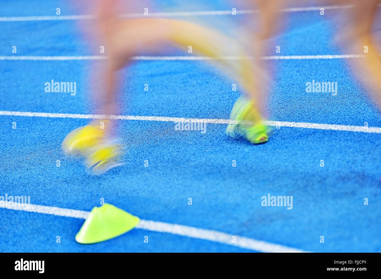 Blurred athletes by a slow camera shutter speed competing on blue ...