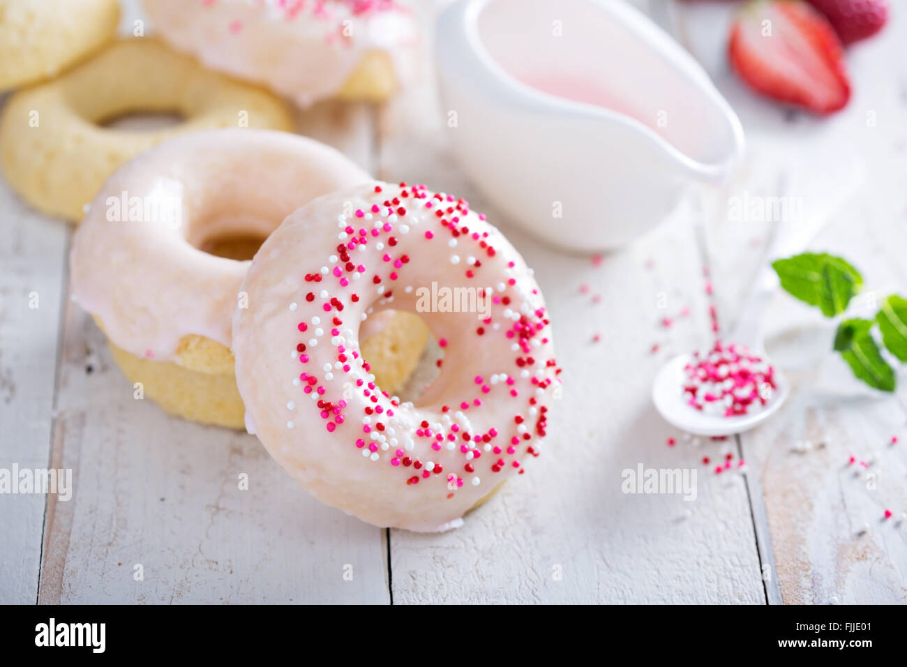 Baked donuts with pink glaze Stock Photo - Alamy
