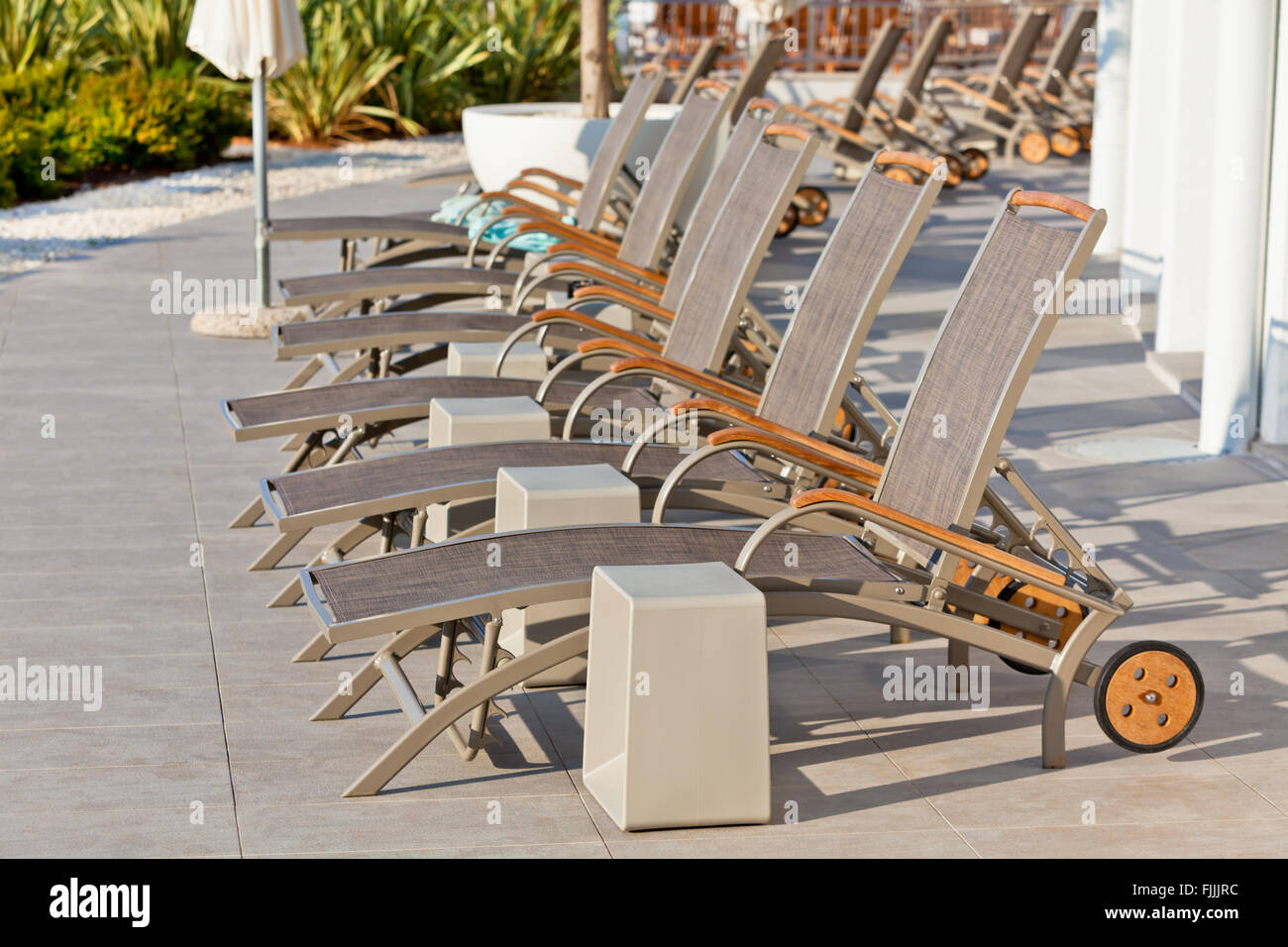Hotel Wooden Poolside Chairs. Horizontal shot Stock Photo - Alamy