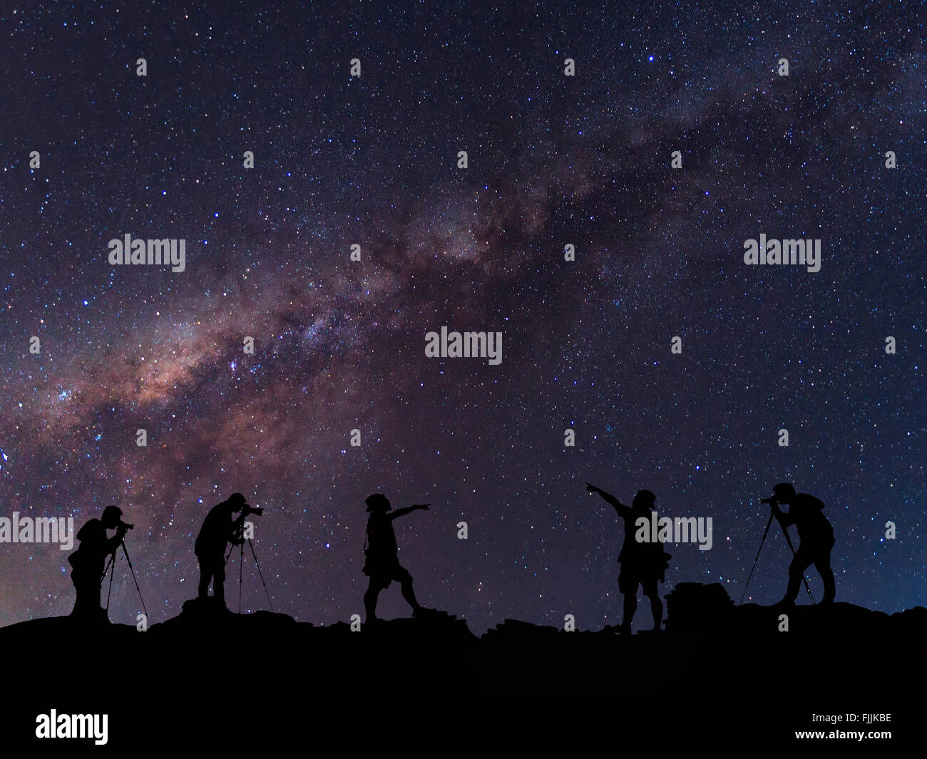 Star-catcher. A person is standing next to the Milky Way galaxy ...