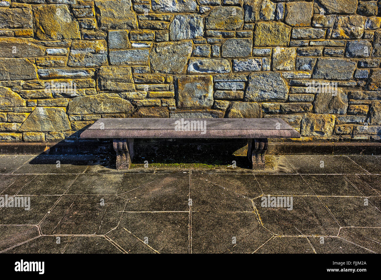 Stone wall with bench Stock Photo - Alamy