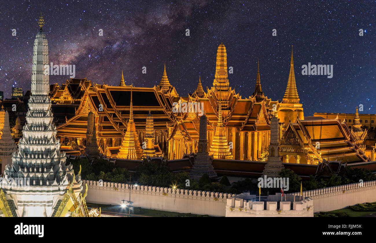 The beauty of the Emerald Buddha Temple at Milky way galaxy with stars ...