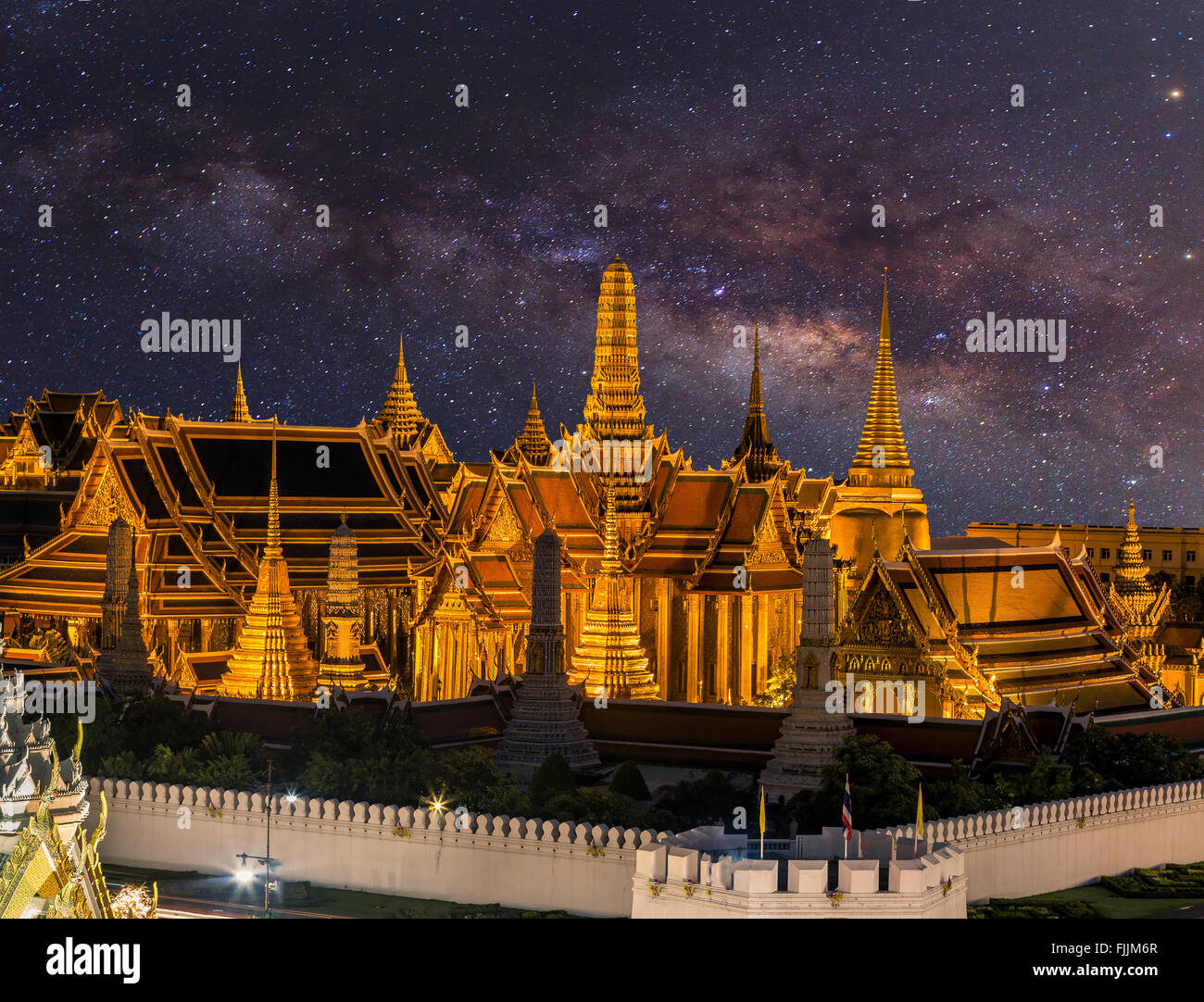 The beauty of the Emerald Buddha Temple at Milky way galaxy with stars ...
