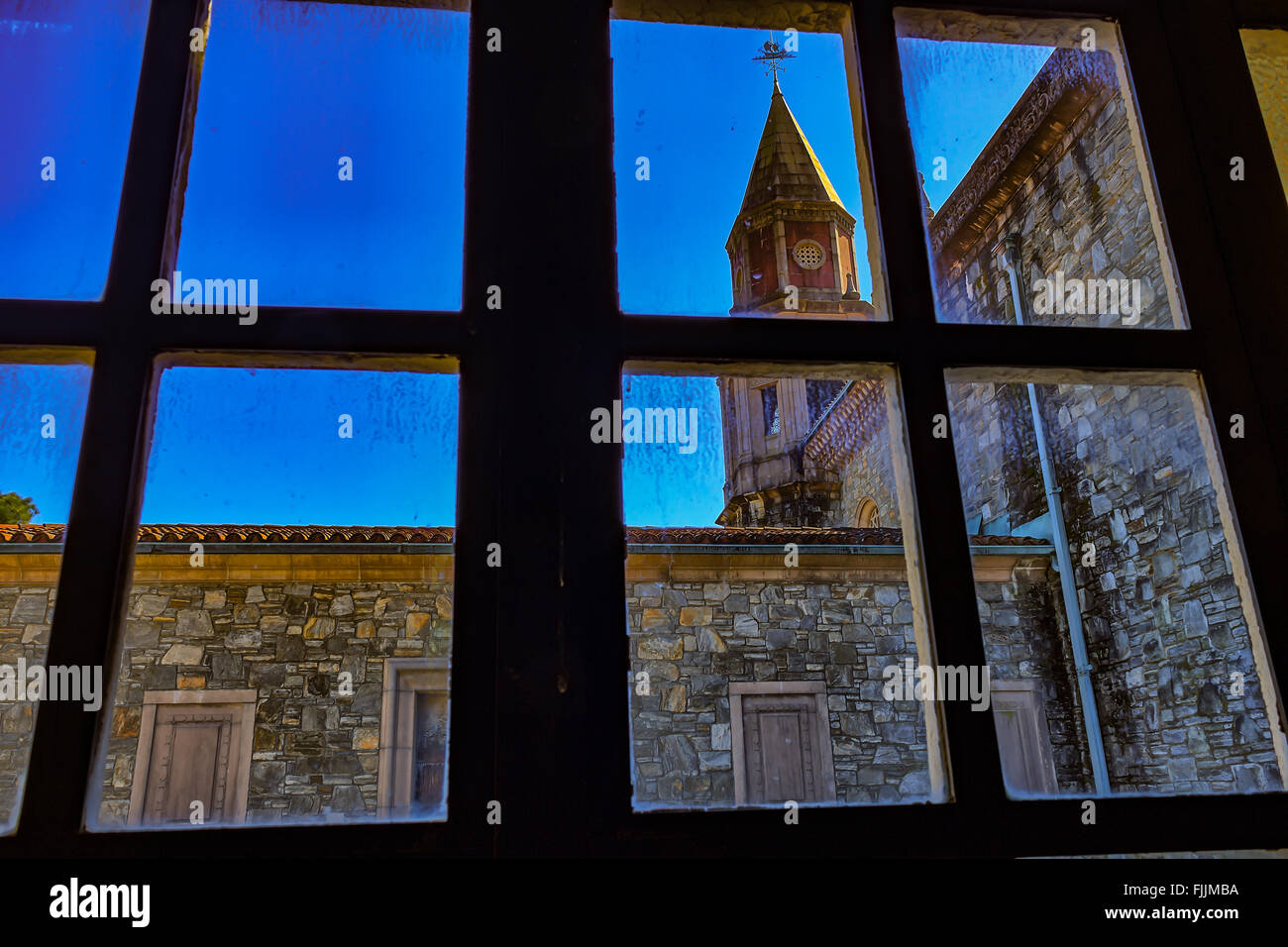 Looking through window at stone tower Stock Photo - Alamy