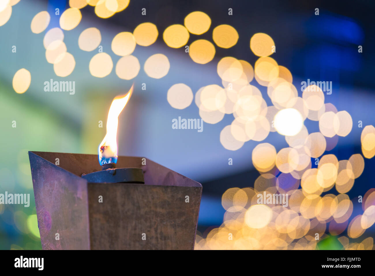 Flaming torch on beautiful bokeh background Stock Photo - Alamy