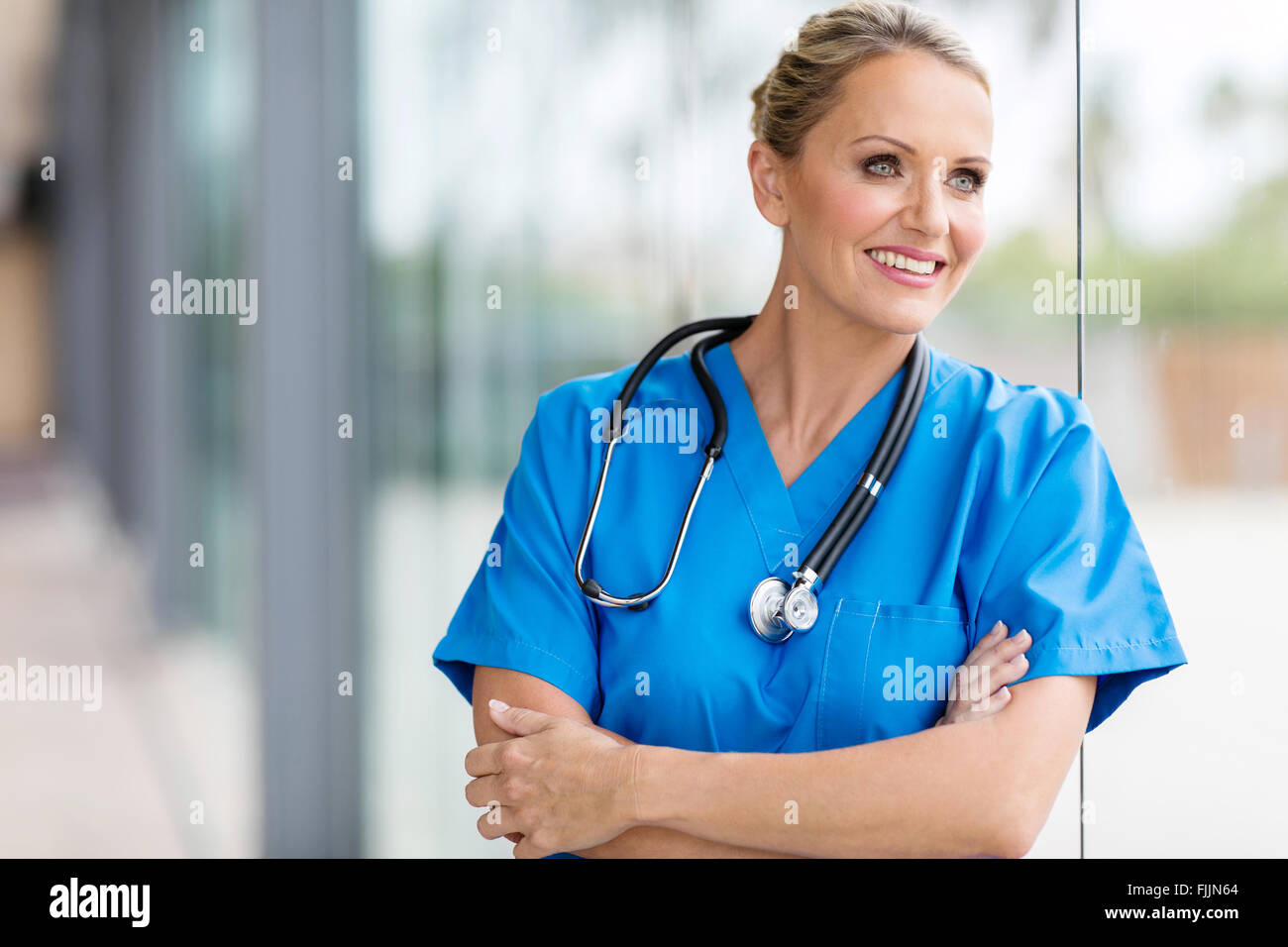 beautiful female medical doctor looking outside window Stock Photo - Alamy