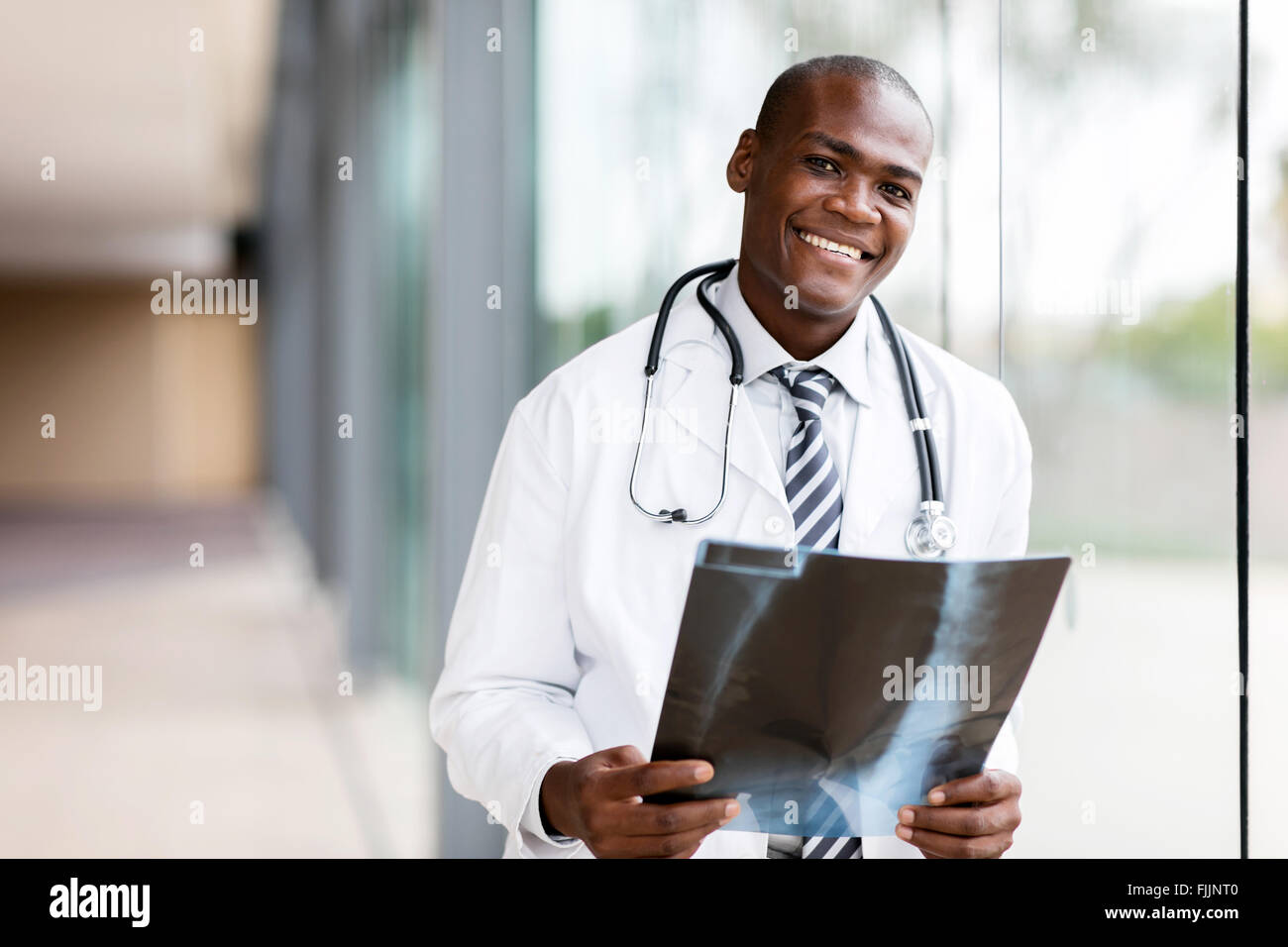 portrait young African medical doctor holding patient's x-ray Stock ...