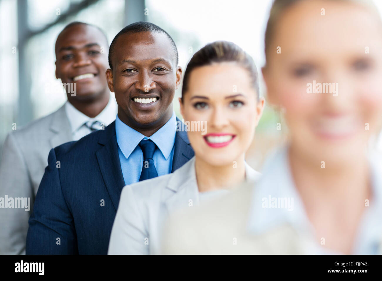 happy African American businessman standing in a row with colleagues ...
