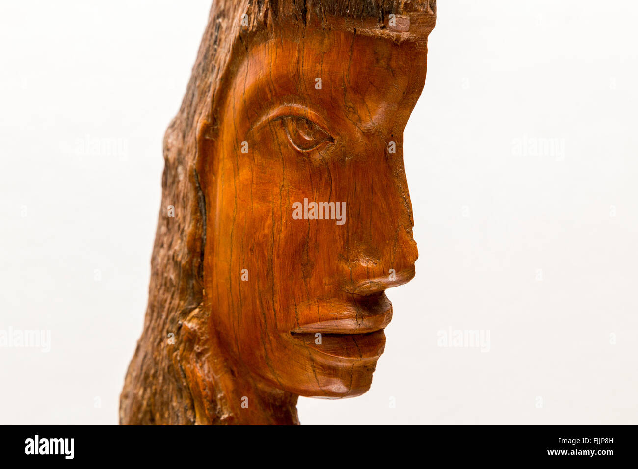 Piece of art of a wooden face at half Stock Photo - Alamy