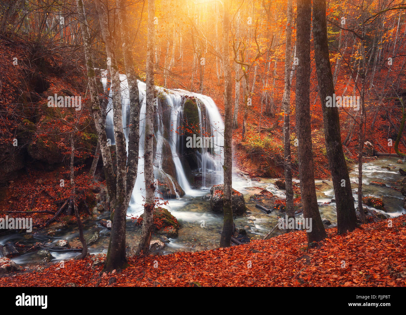 Beautiful waterfall at mountain river in colorful autumn forest with ...