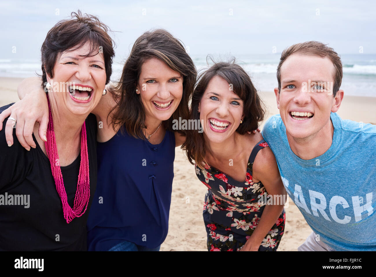 Family laughing and having fun on the beach together Stock Photo - Alamy