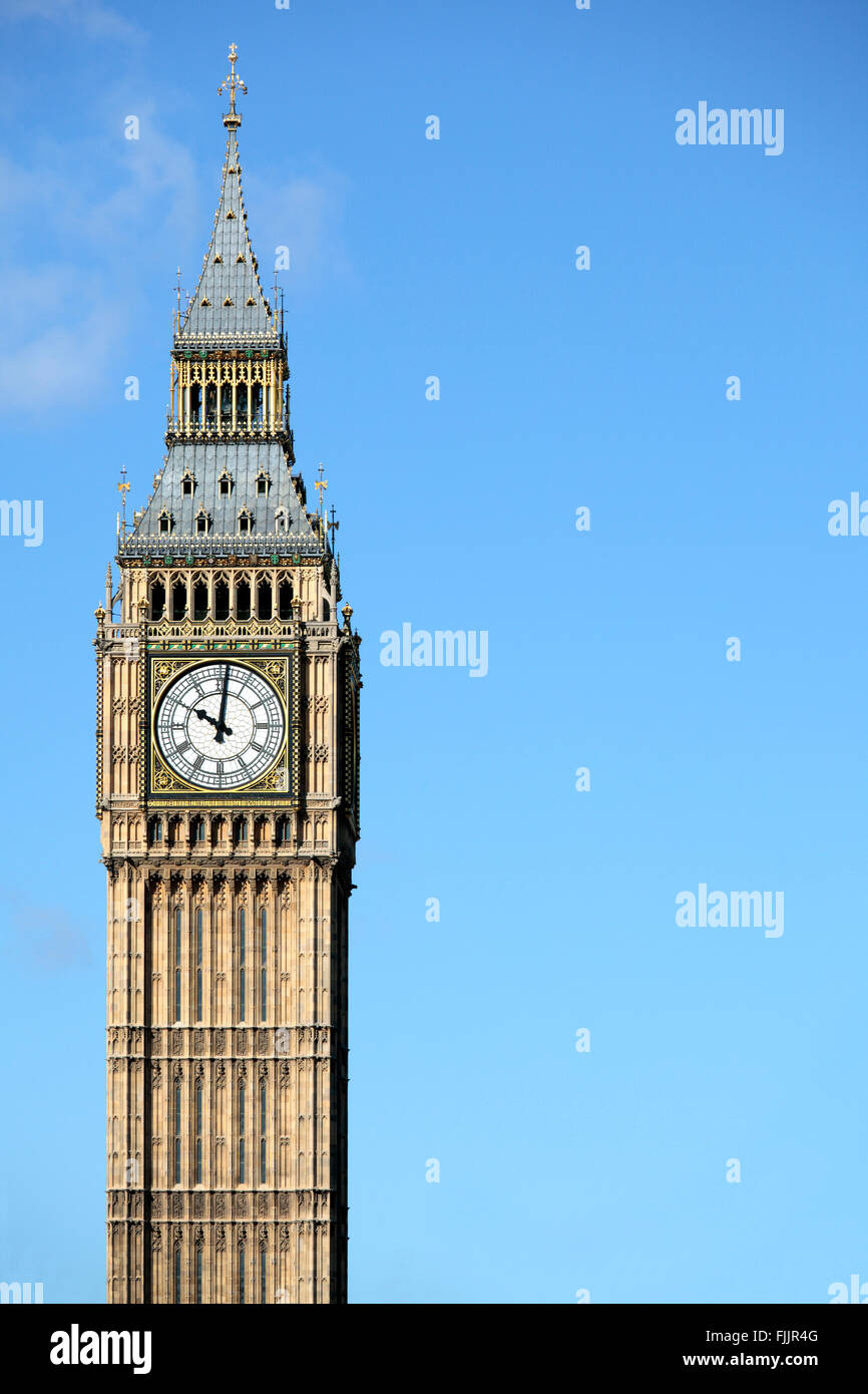 Big Ben clock tower isolated against a deep blue summer sky. Space for ...
