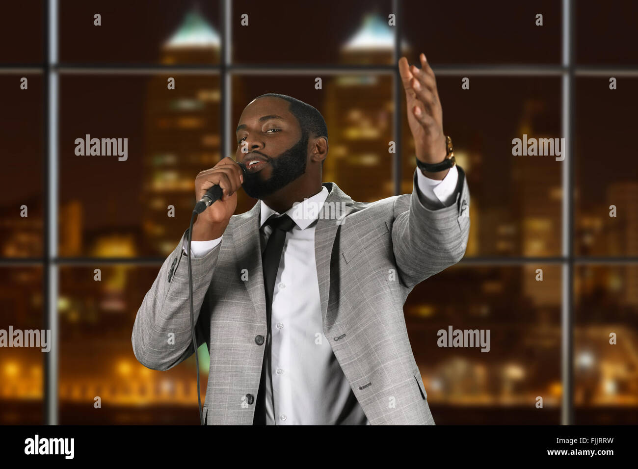 Darkskinned preacher speaks to people. Night at the Lord's house ...