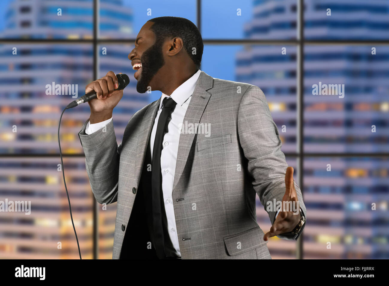 Expressive black singer. Evening vocal performance. Impressive vocal ...