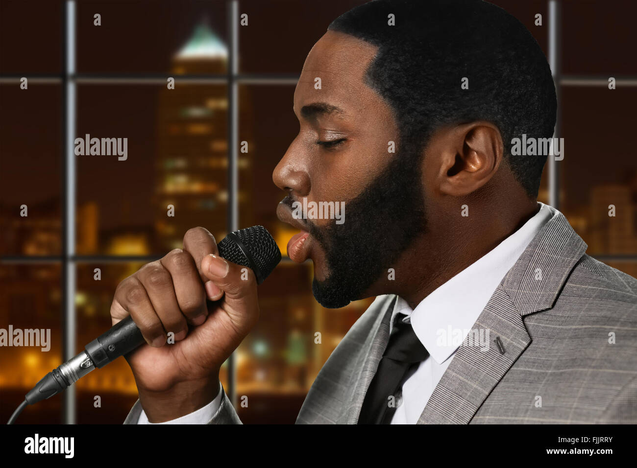 Darkskinned man sings jazz. Singer on urban background. Professional ...