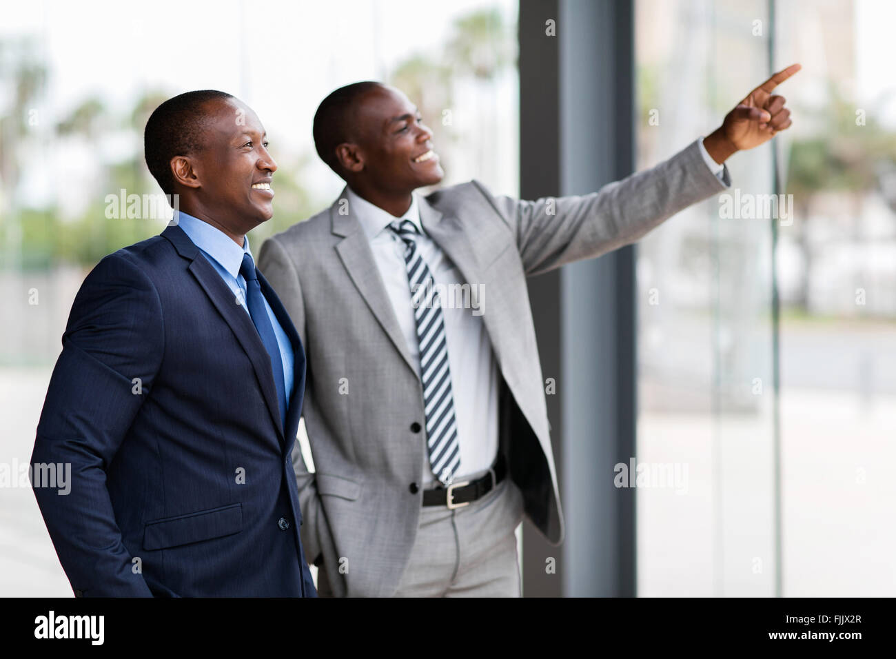 happy African business men pointing in modern office Stock Photo - Alamy