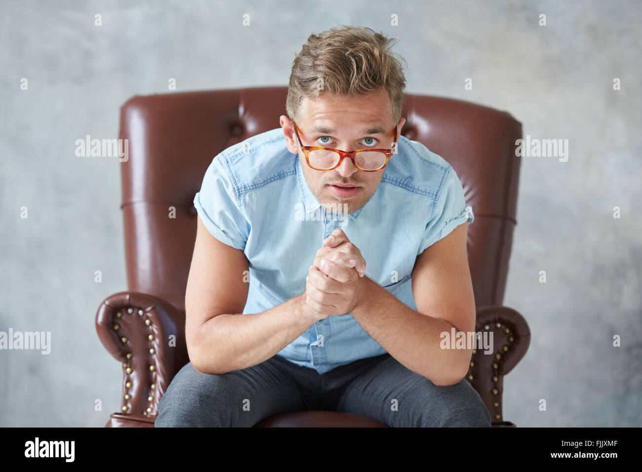 Portrait of a stylish intelligent man stares into the camera, small ...