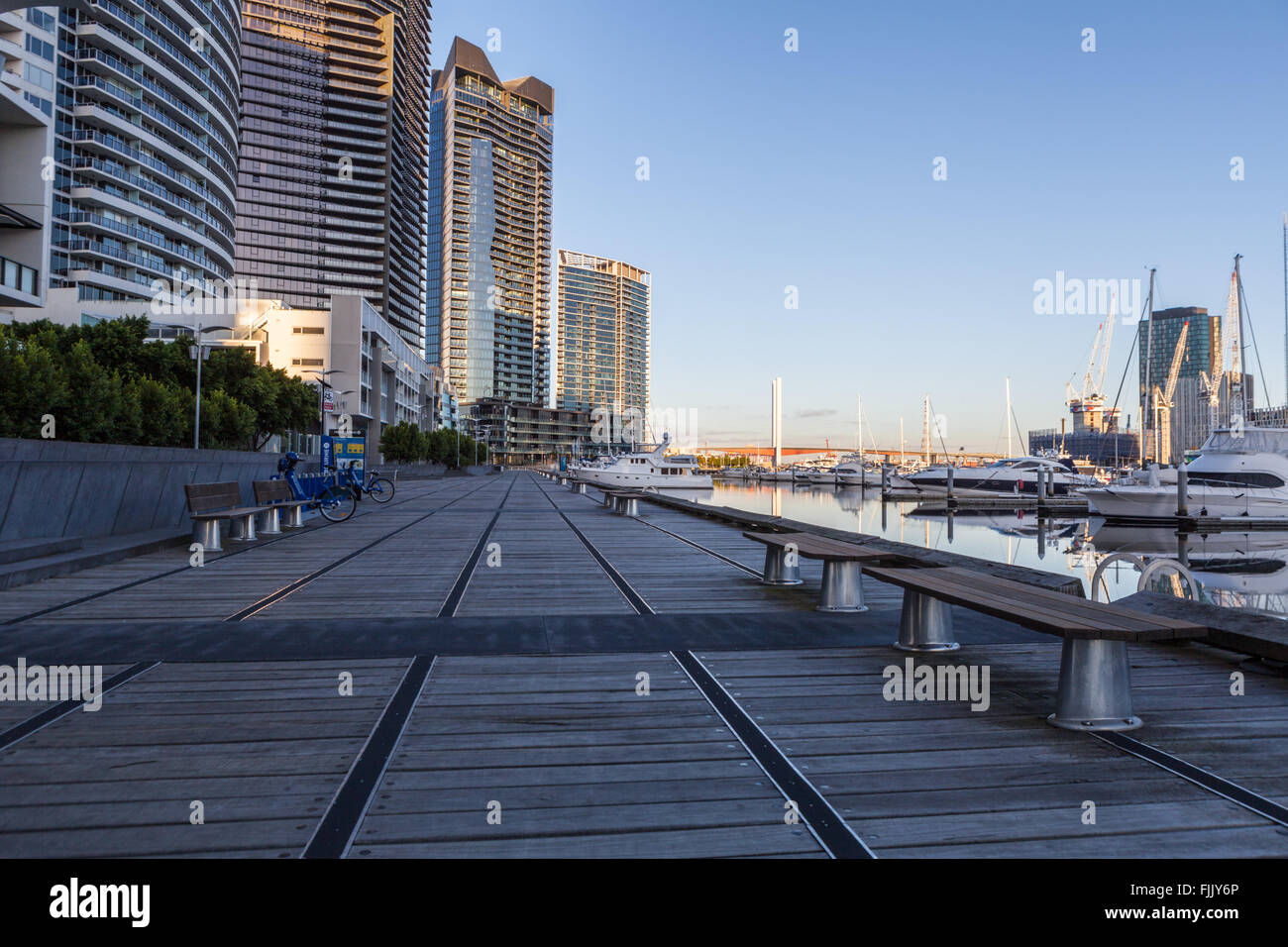 Docklands waterfront promenade with high rise buildings and docked ...