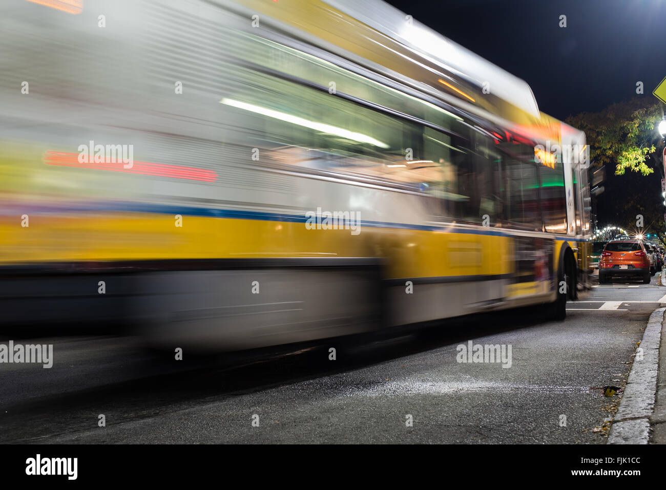 A bus pulling into the stop on a city street in Boston Stock Photo - Alamy