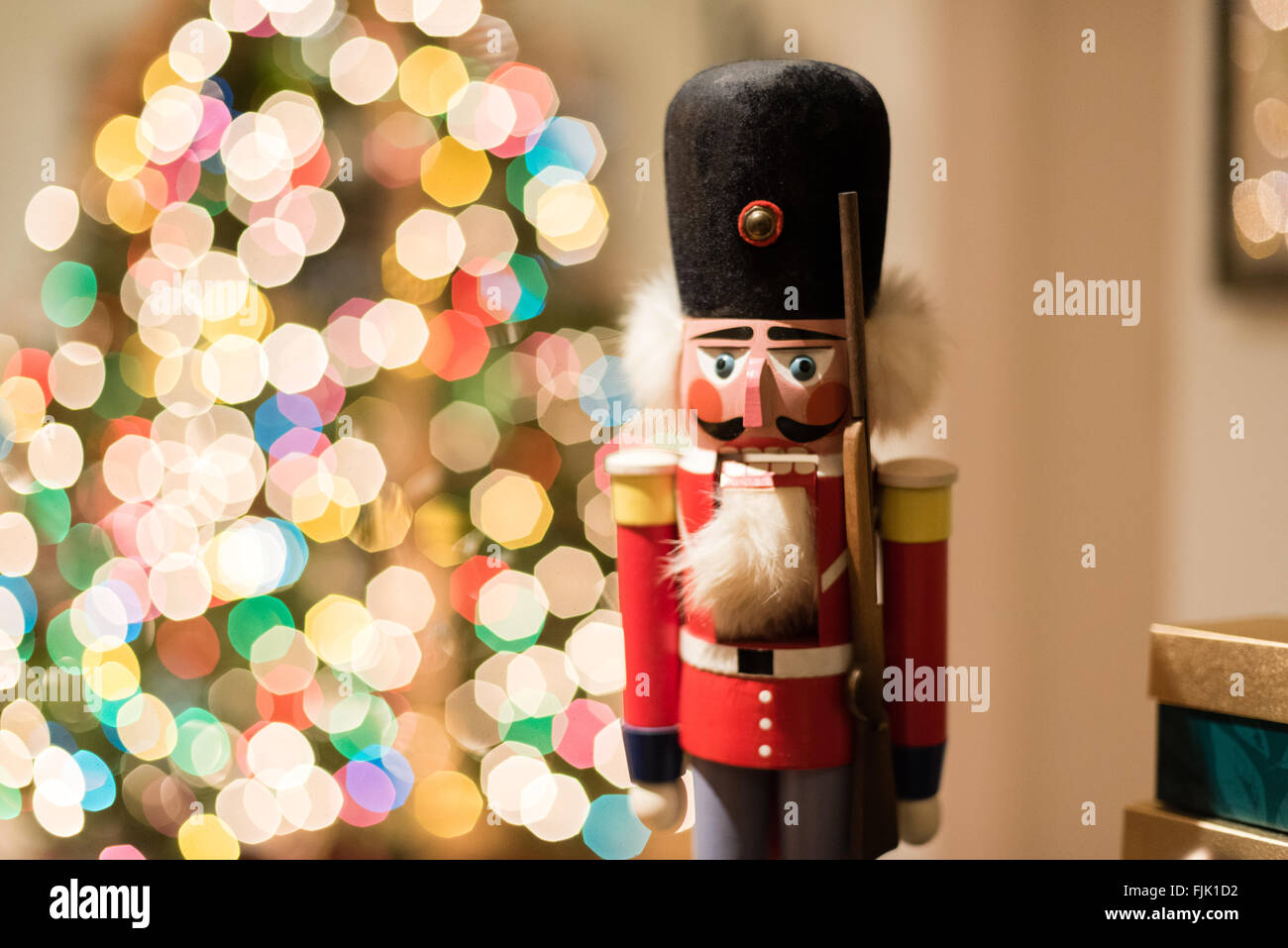 A Christmas nutcracker with tree lights in the background Stock Photo ...