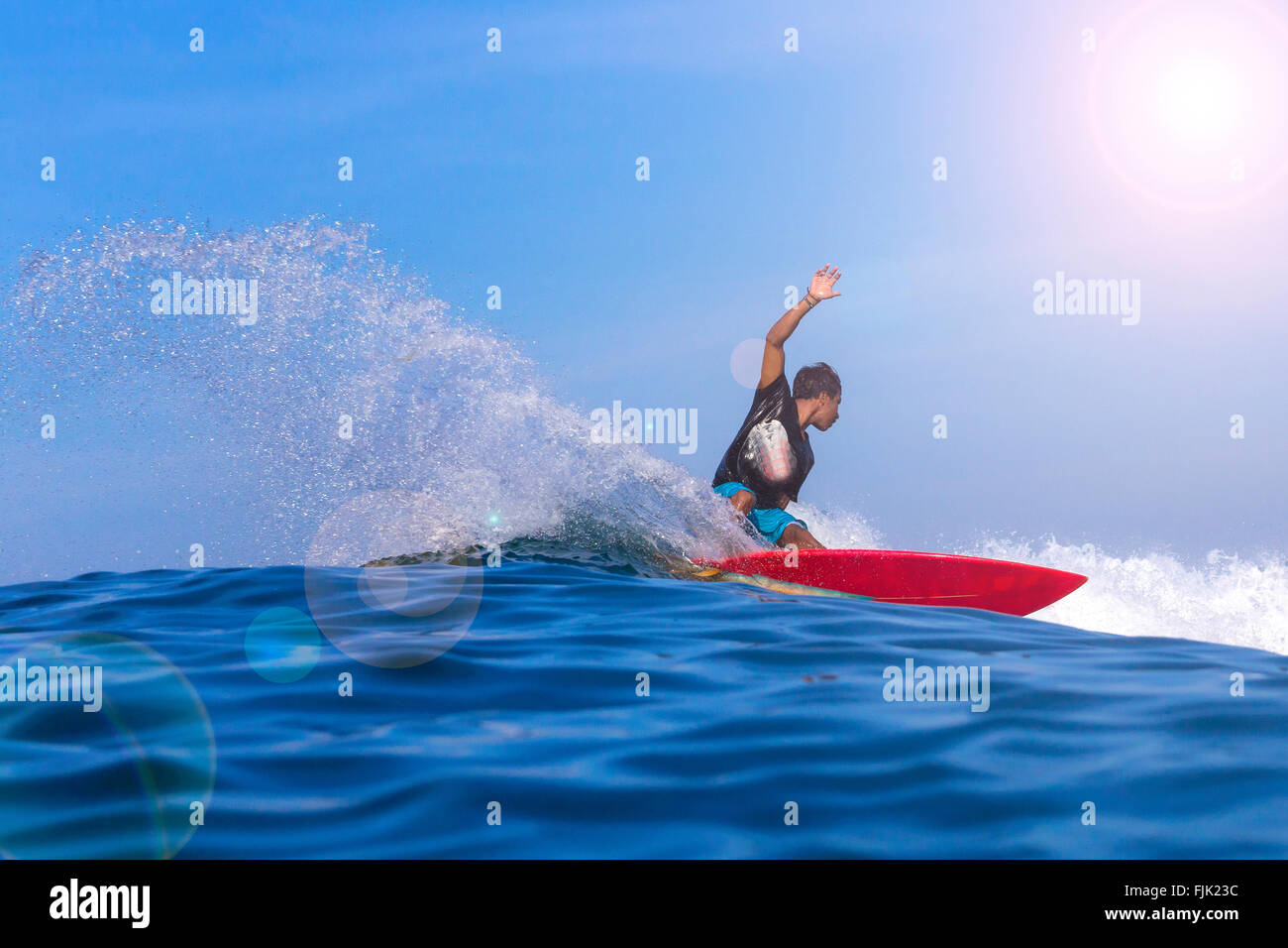 Surfer on a wave Stock Photo - Alamy