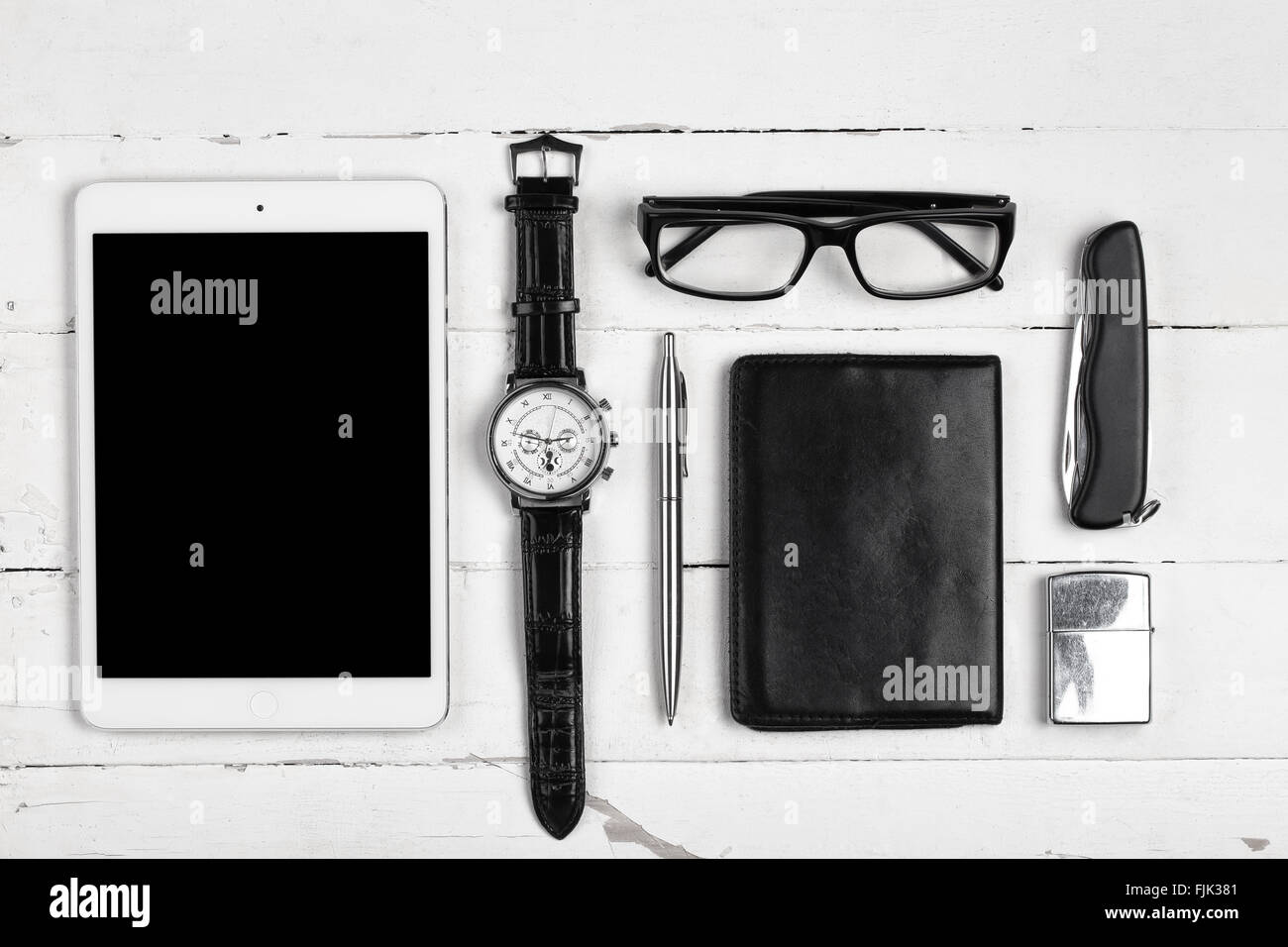 Business still-life with tablet computer glasses and cigarette lighter ...