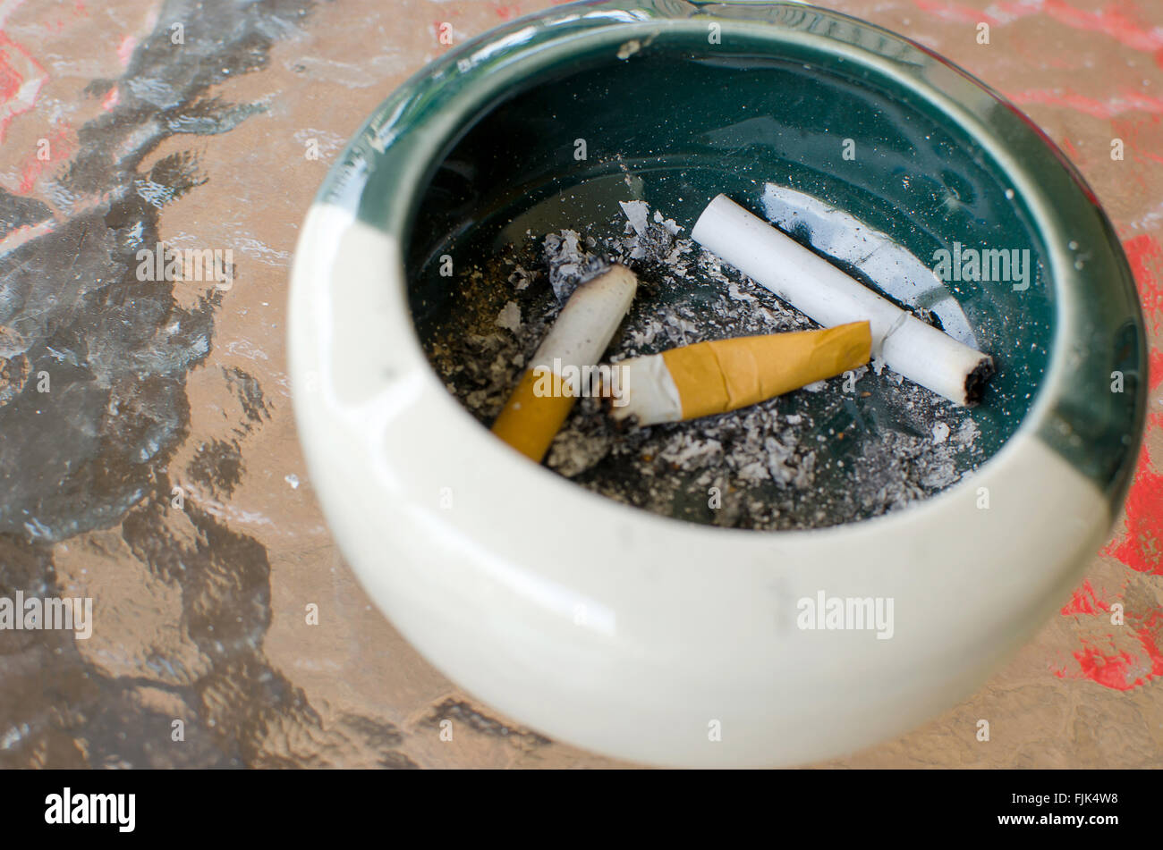 Bad addiction. Ashtray and cigarettes close-up Stock Photo - Alamy