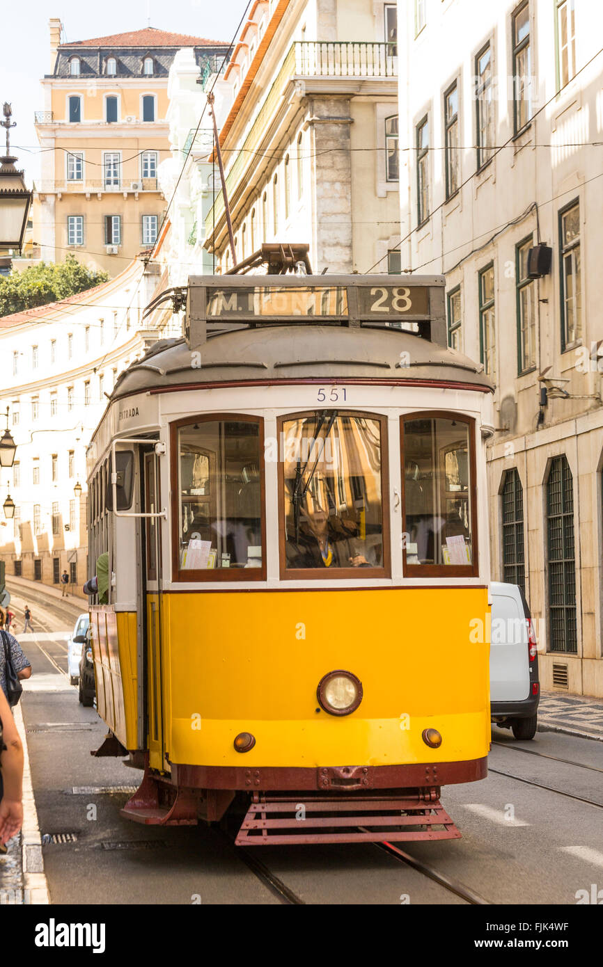Electric trolly tram mass transit on a city street in downtown Lisbon ...