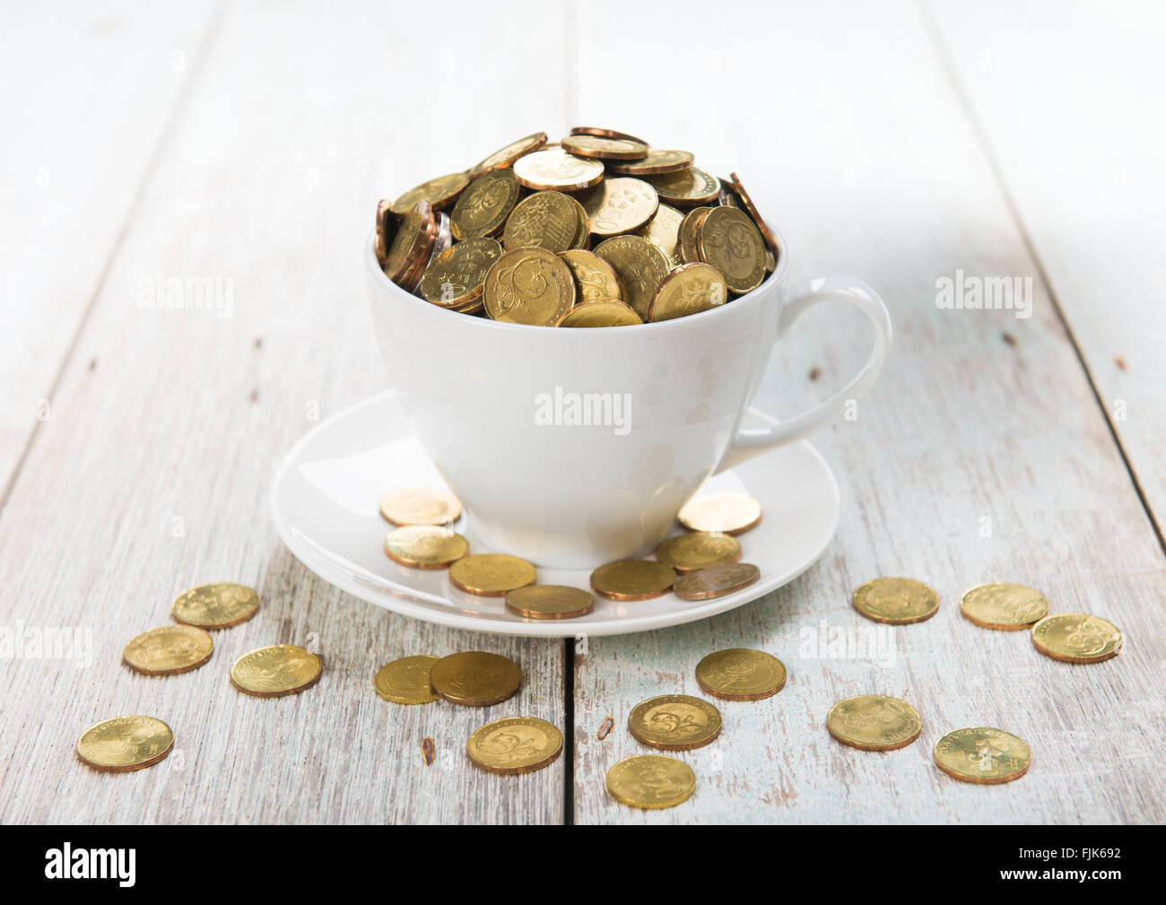 cup of coffee with gold coins of malaysian ringgit Stock Photo - Alamy