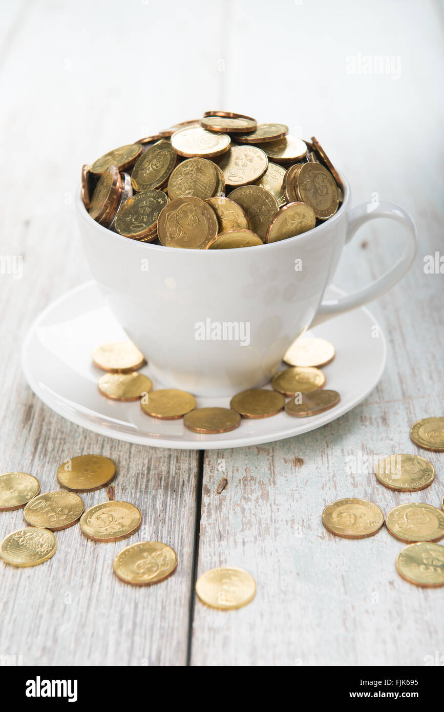 cup of coffee with gold coins of malaysian ringgit Stock Photo - Alamy