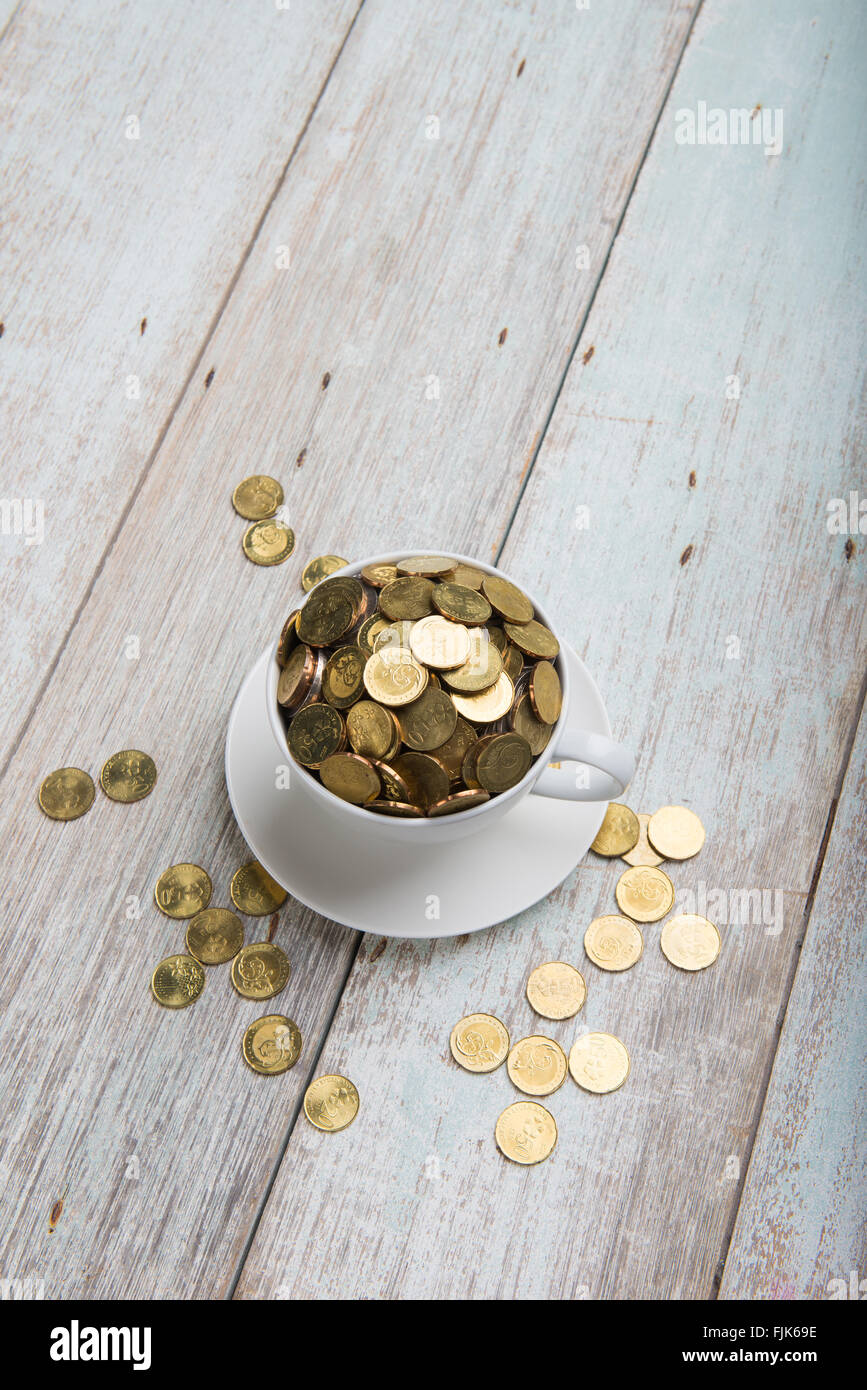 cup of coffee with gold coins of malaysian ringgit Stock Photo - Alamy