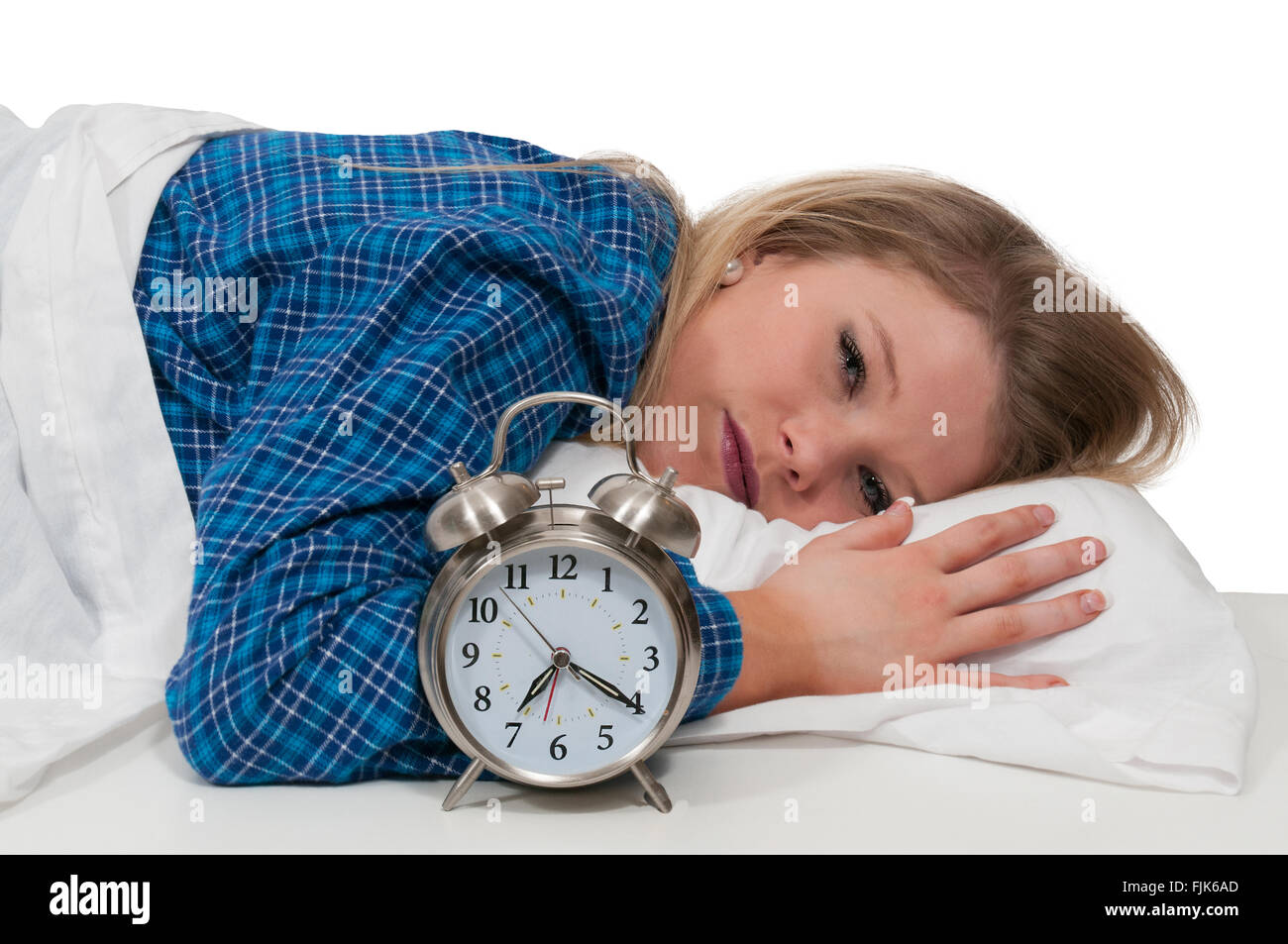 Beautiful young sleeping woman waking up with an alarm clock Stock ...